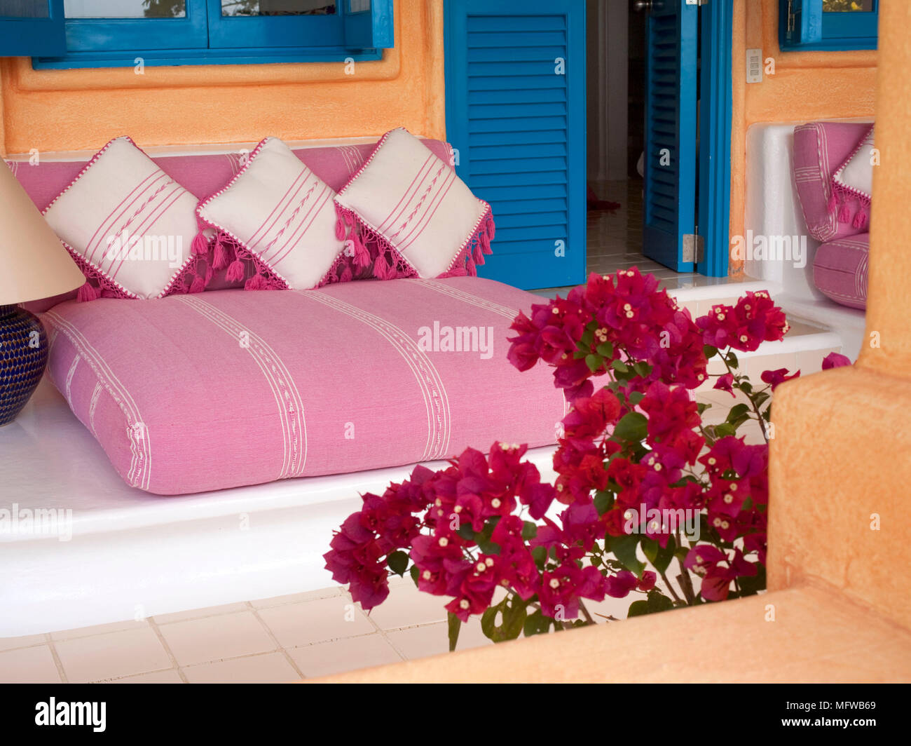Pink cushions on veranda Stock Photo - Alamy