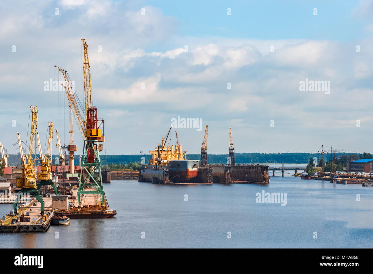 Yellow bulk carrier standing at the old shipyard in the dock Stock ...