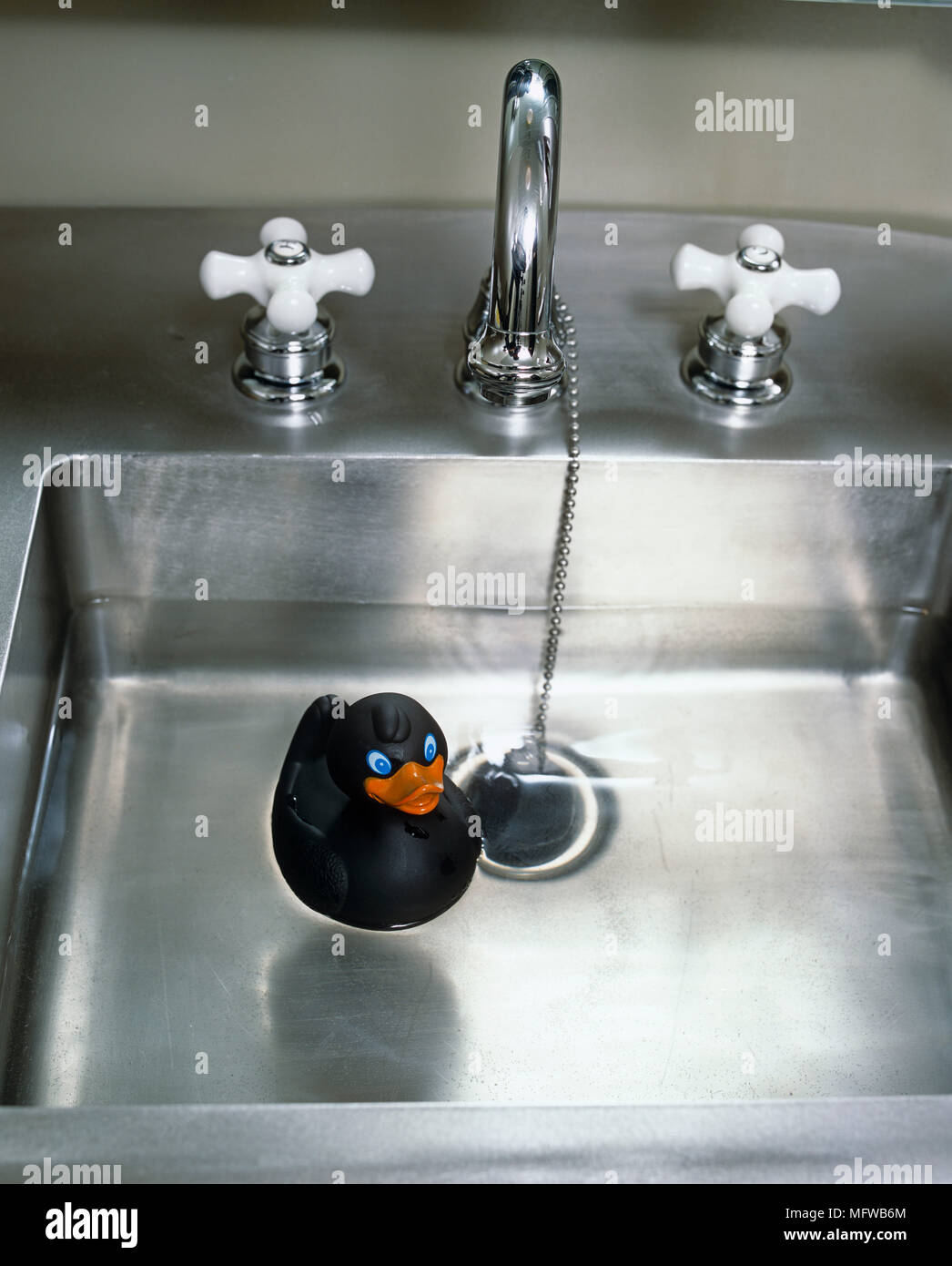 Plastic duck floating in stainless steel sink full of water Stock Photo ...
