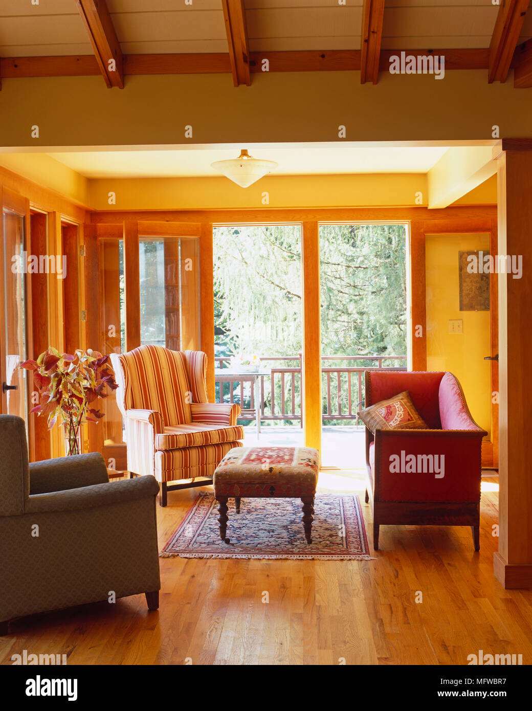 Upholstered seating around ottoman in yellow country style room Stock ...