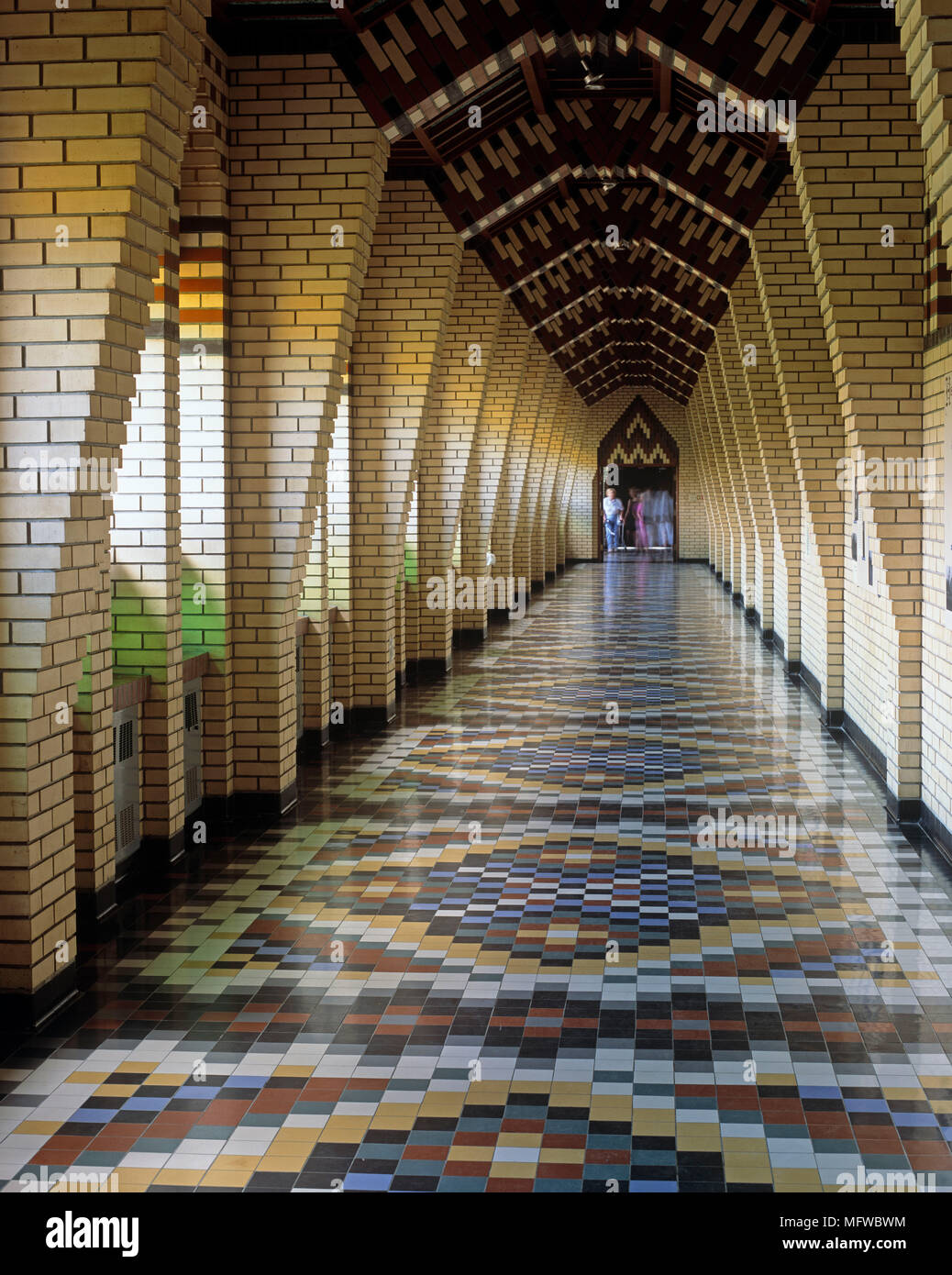 View along richly tiled corridor with archways Stock Photo - Alamy