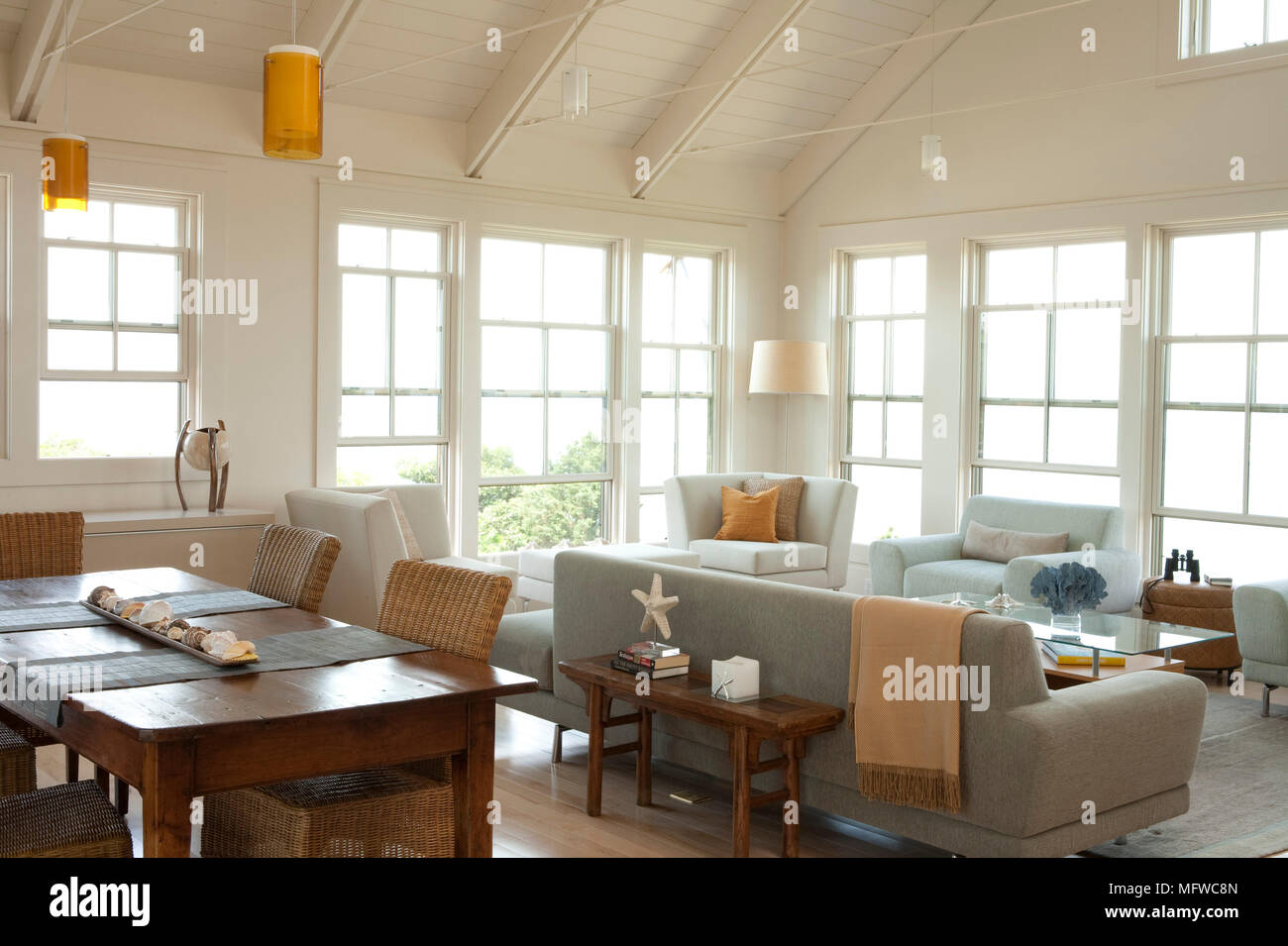 Wooden dining table and seating in open plan modern country style ...
