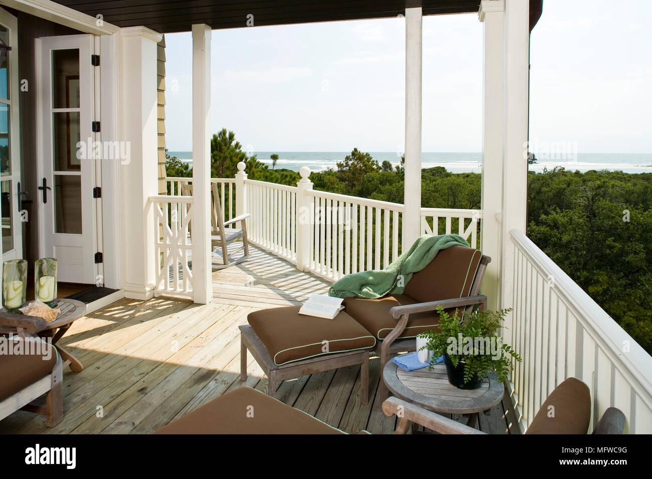 Seating on veranda of country style house Stock Photo - Alamy