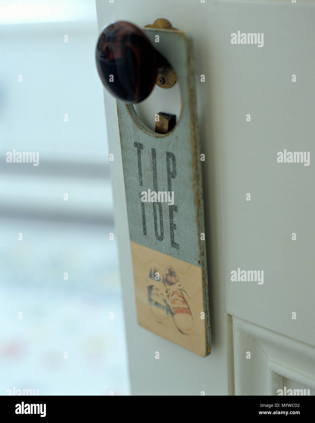 Wooden sign saying tip toe hanging on door handle Stock Photo - Alamy