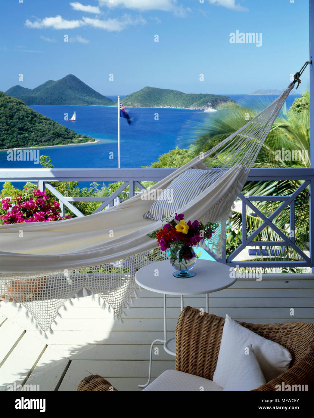 Hammock on veranda overlooking tropical island Stock Photo - Alamy