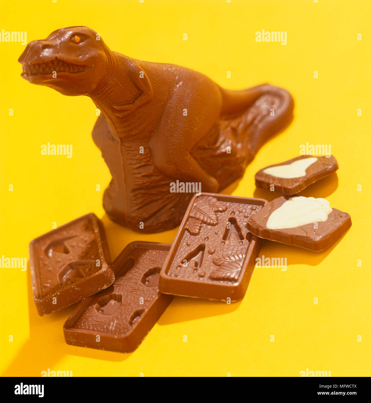 Chocolate in the shape of a dinosaur and chocolate pieces Stock Photo ...