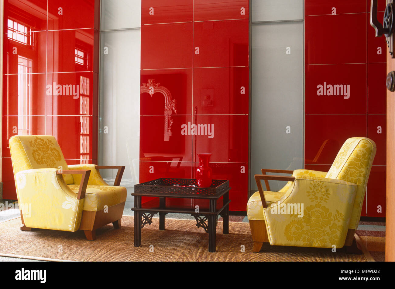 Pair of upholstered armchairs facing each other across ethnic table in ...