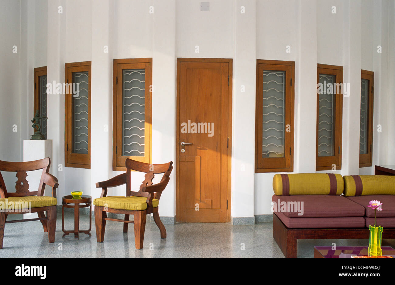 Modern seating in front of door in ethnic style sitting room Stock ...