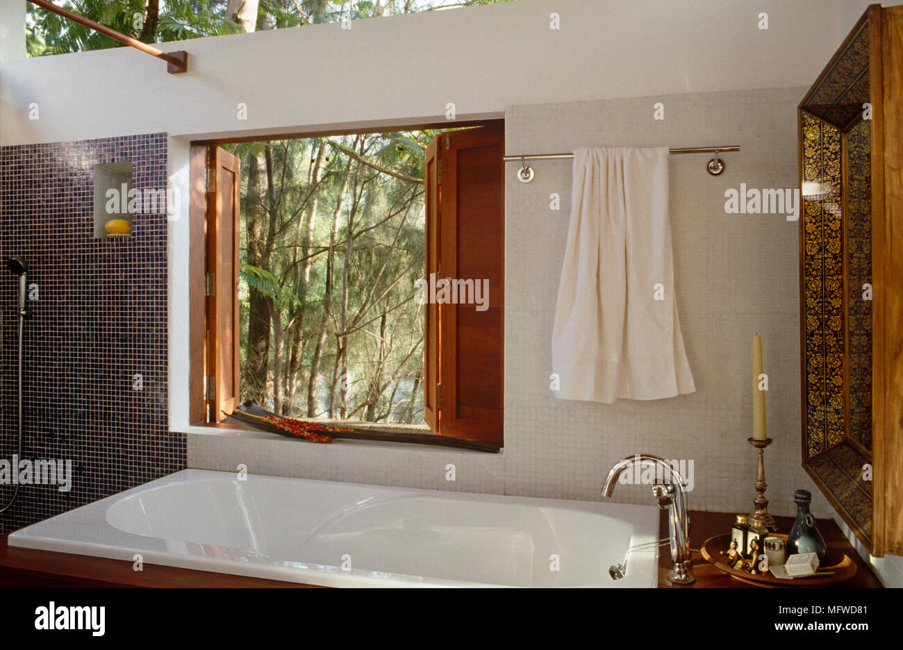 Bathtub below window in bathroom open to the elements Stock Photo - Alamy