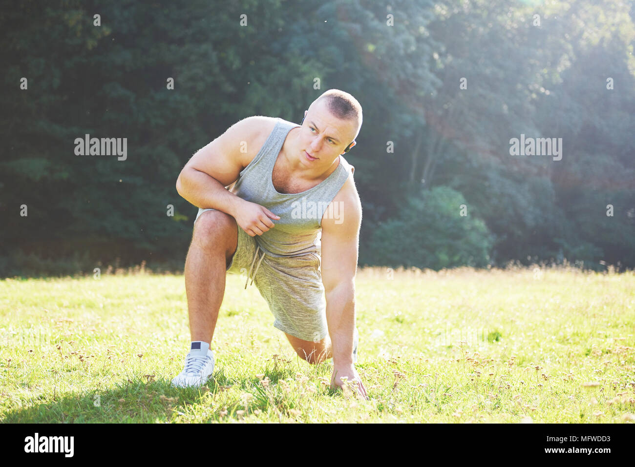A young sportsman getting ready for athletic and fitness training ...
