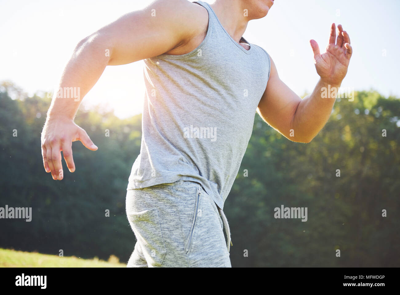 Fitness man athlete jogging in the nature during sunset. Person running ...