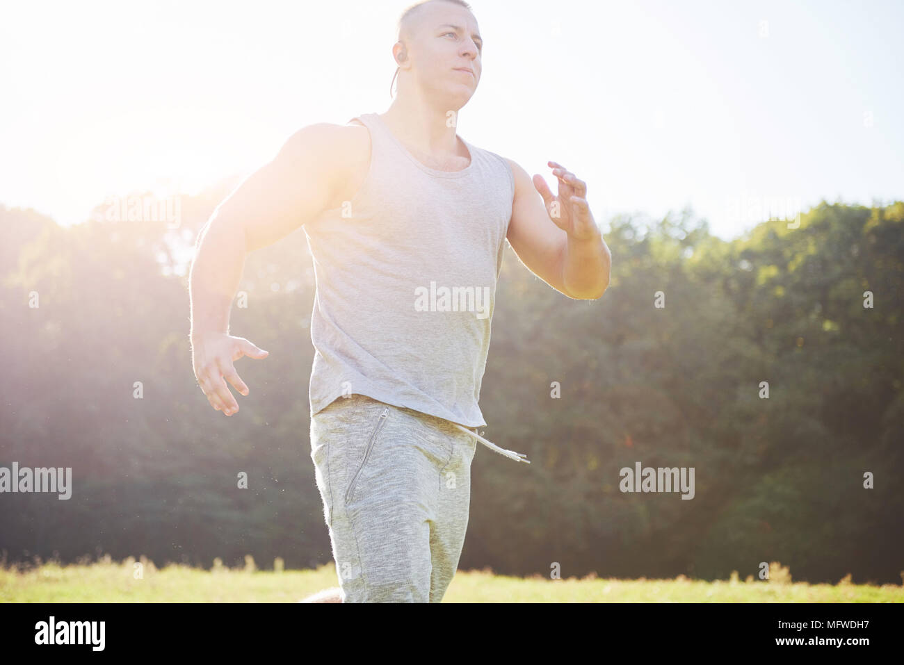 Fitness man athlete jogging in the nature during sunset. Person running ...