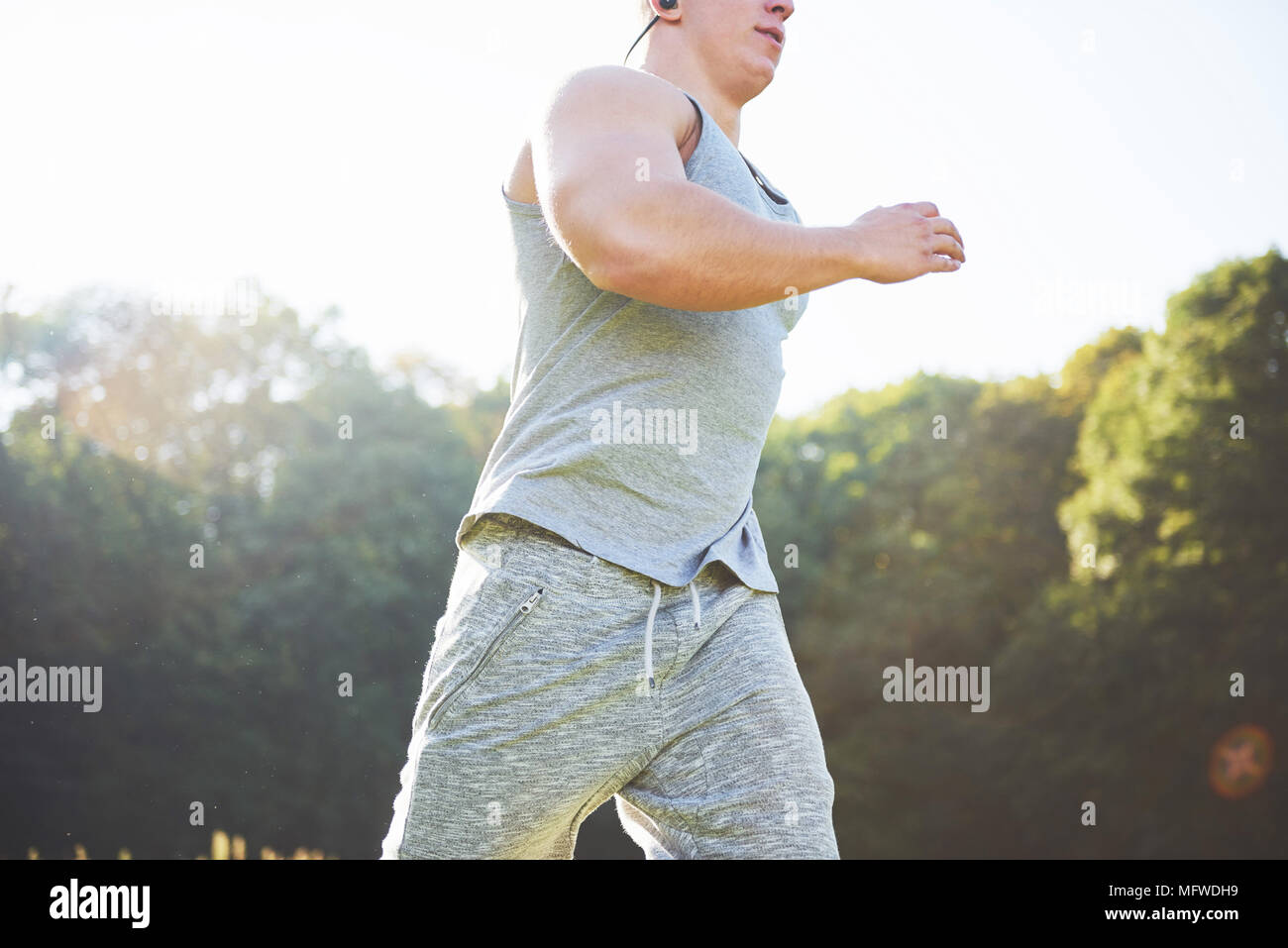 Fitness man athlete jogging in the nature during sunset. Person running ...