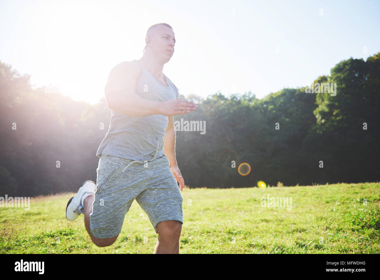 Fitness man athlete jogging in the nature during sunset. Person running ...