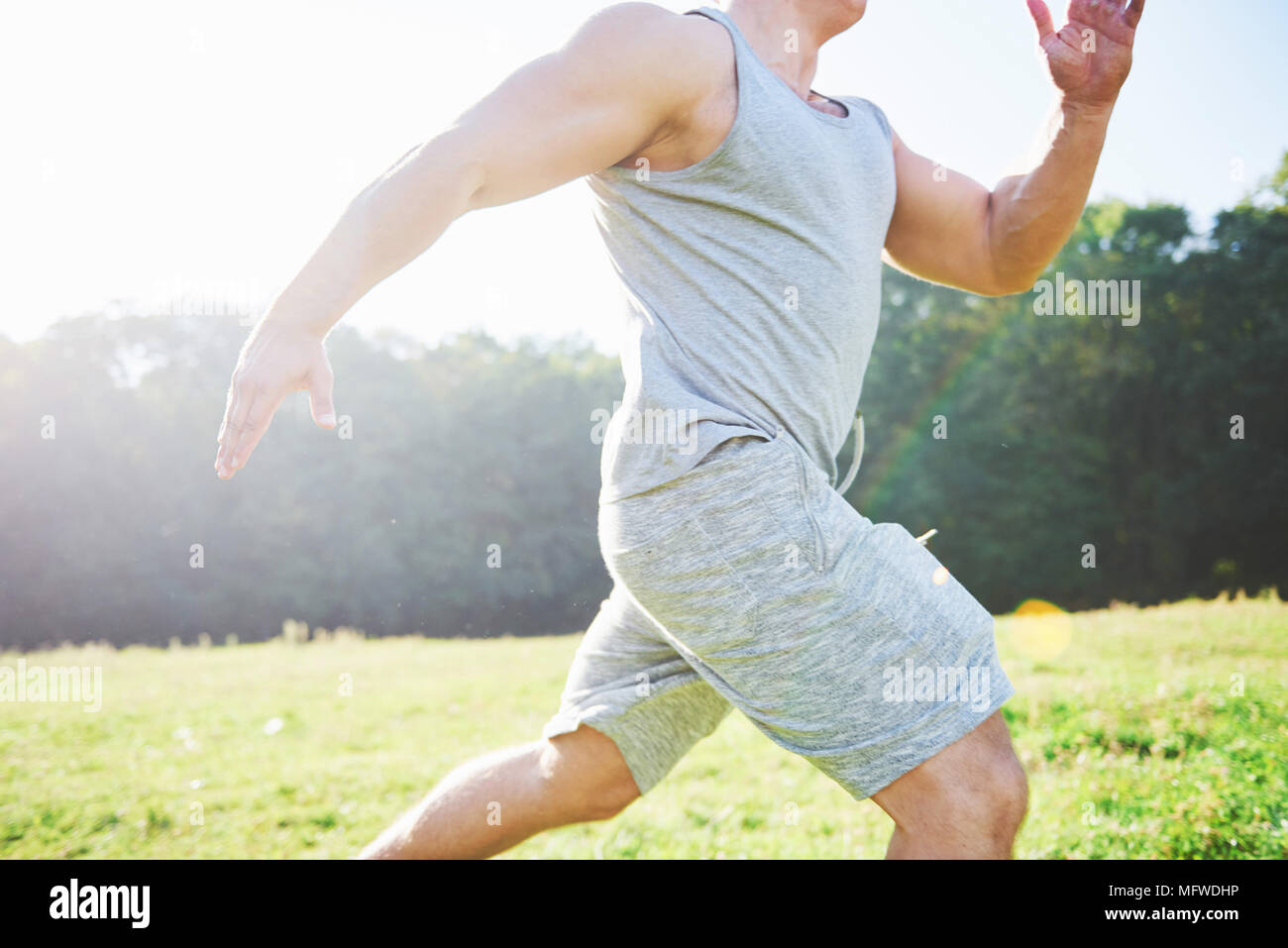 Fitness man athlete jogging in the nature during sunset. Person running ...