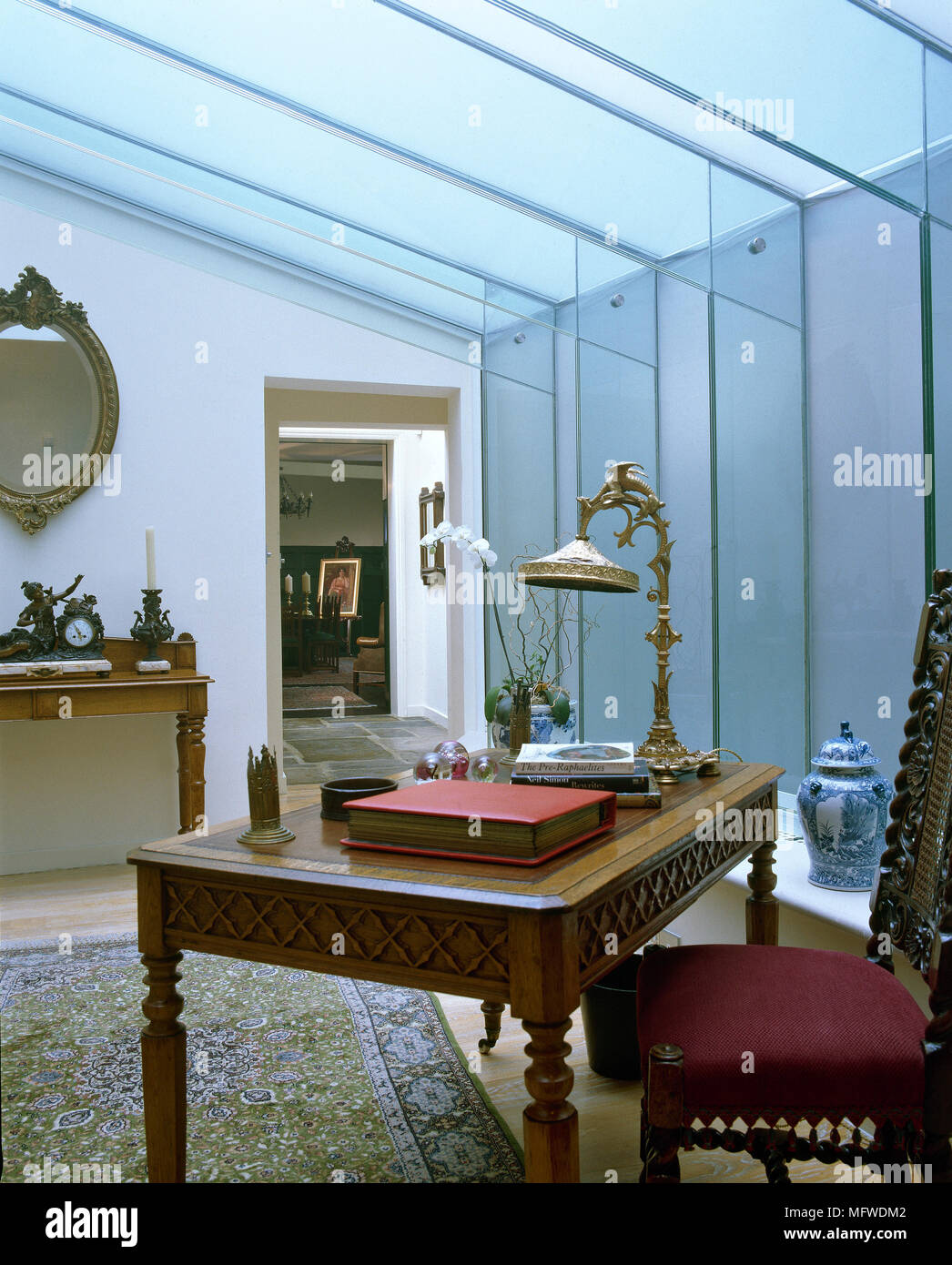 Study room with modern glass panels, period table and chair Stock Photo ...