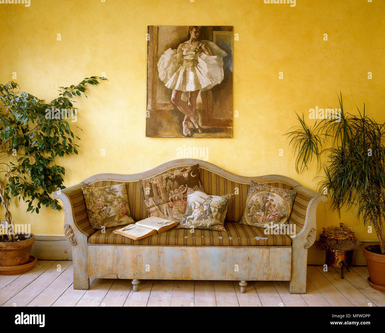 Carved wooden sofa with distressed finish and striped upholstery ...