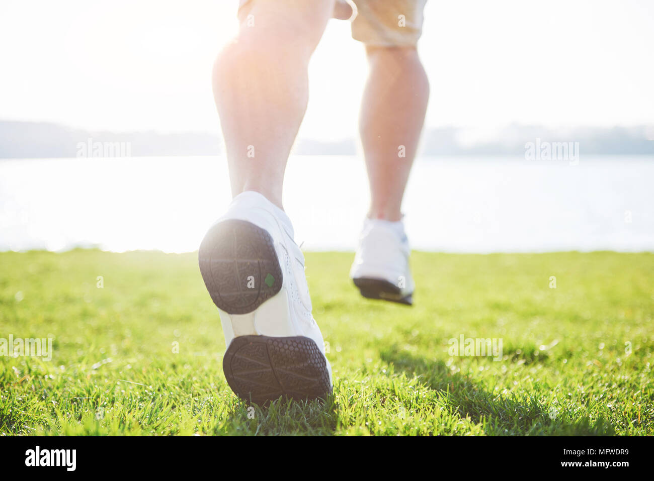 Outdoor cross-country running in summer sunshine concept for exercising ...