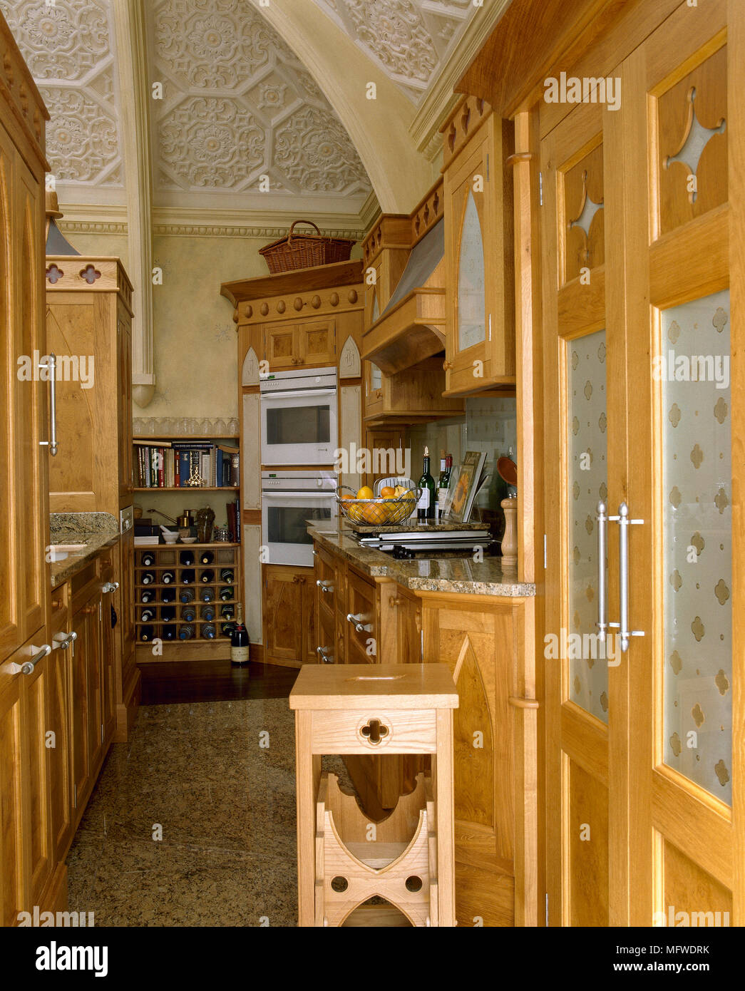 Kitchen with wood units and integral ovens in converted chapel Stock ...