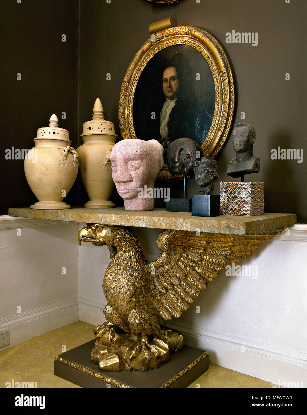 Stone table with golden eagle base displaying figurines and urns Stock ...