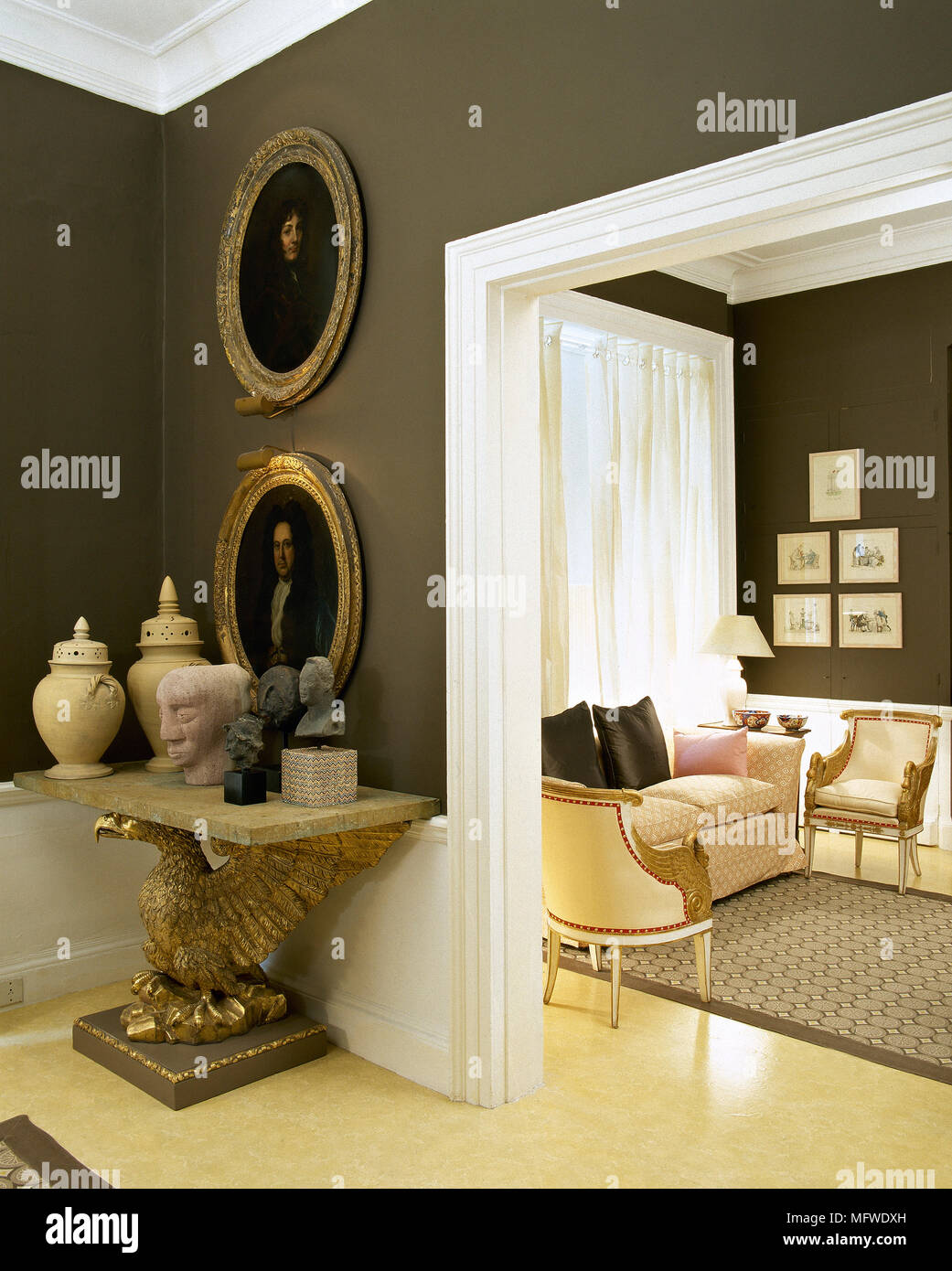 Marble hall table on a golden eagle base next to open doorway Stock ...