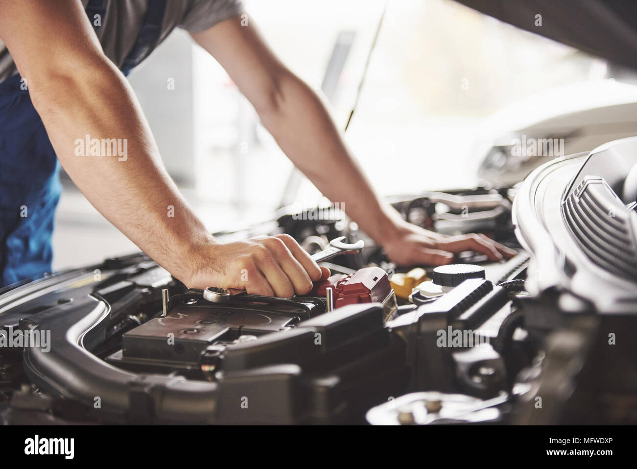 Auto mechanic working in garage. Repair service Stock Photo - Alamy