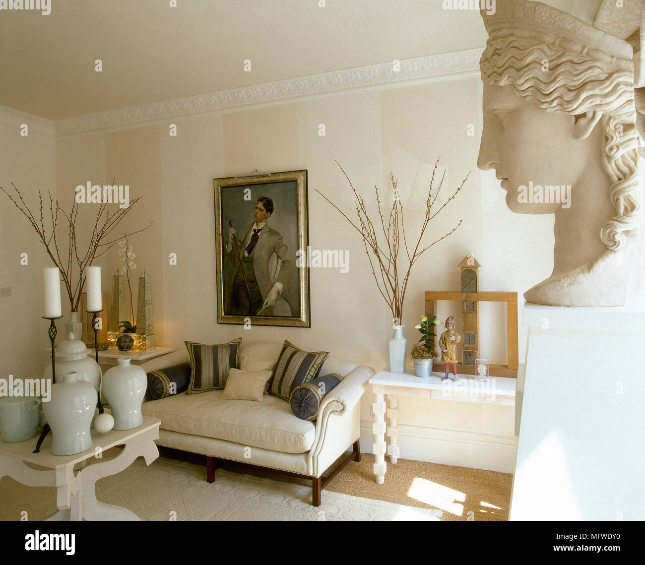 Upholstered sofa and side table with lamp in a neutral sitting room ...