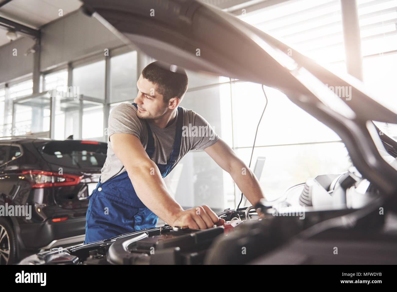 Auto mechanic working in garage. Repair service Stock Photo - Alamy