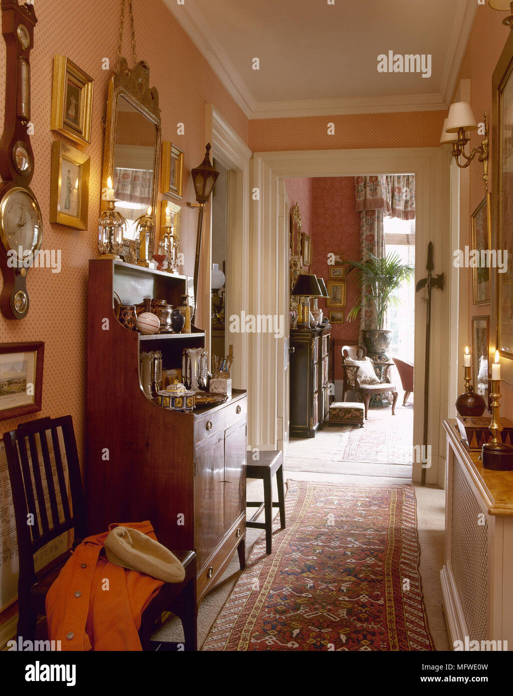 Country style terracotta hallway with side cabinet Stock Photo - Alamy