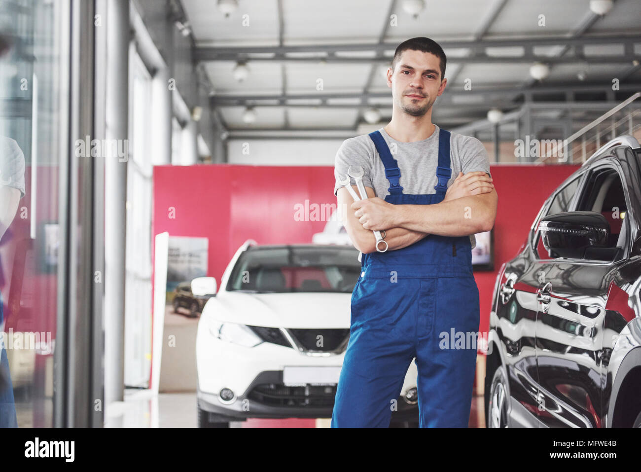 Hand of car mechanic with wrench. Auto repair garage Stock Photo - Alamy