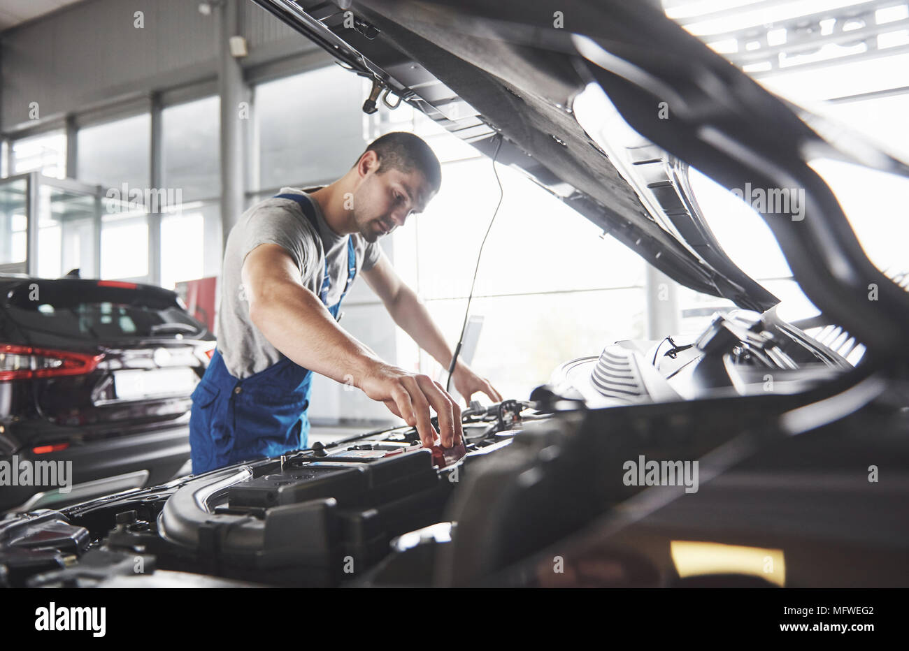 Picture showing muscular car service worker repairing vehicle Stock ...