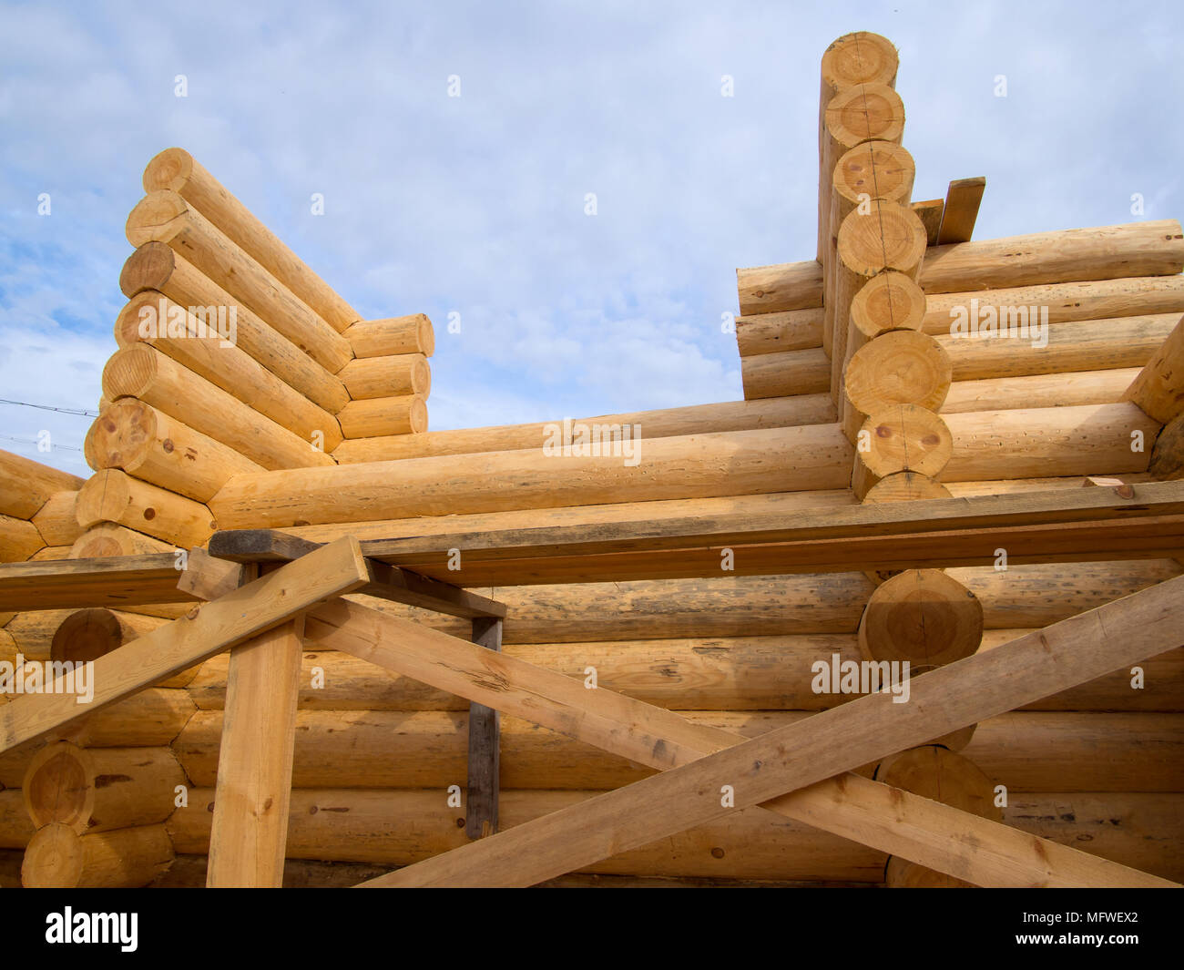 Fragment of stacking logs in the manufacture of logs Stock Photo - Alamy