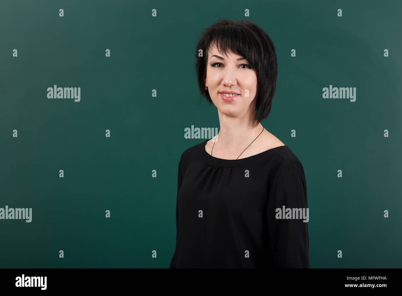 happy girl teacher posing by chalk Board, learning concept, green ...