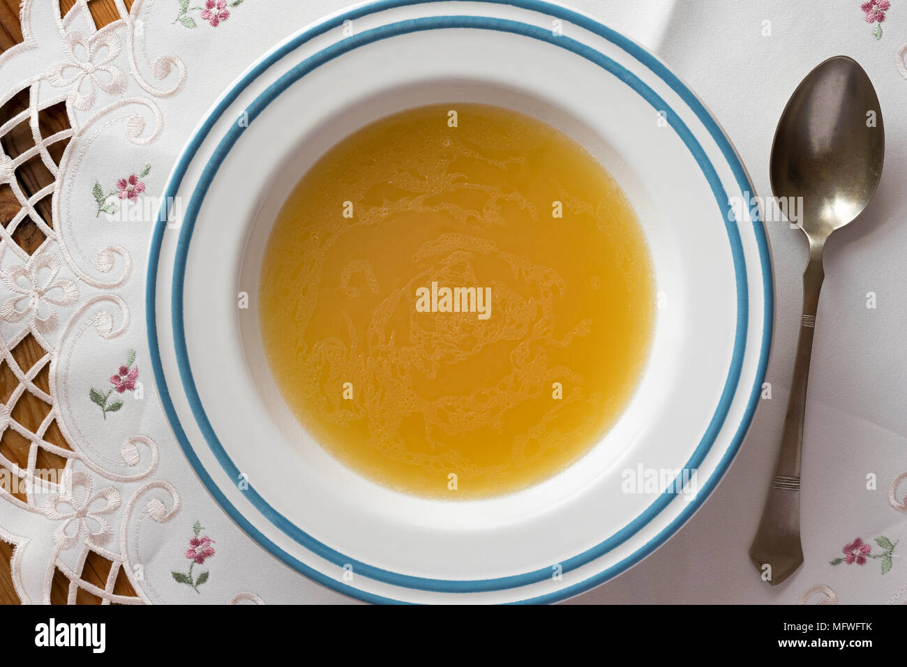 Chicken bone broth in a plate, top view Stock Photo - Alamy