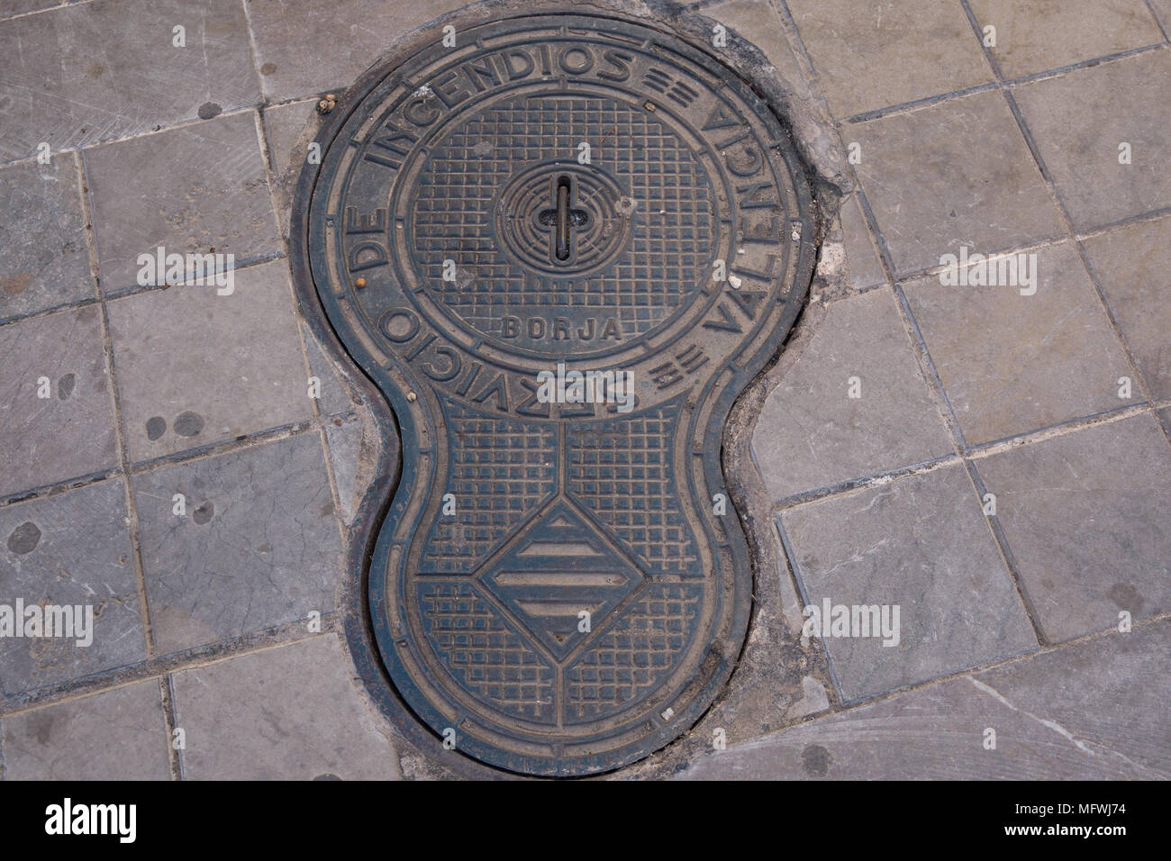 Odd shaped manhole cover in Valencia Spain Stock Photo - Alamy