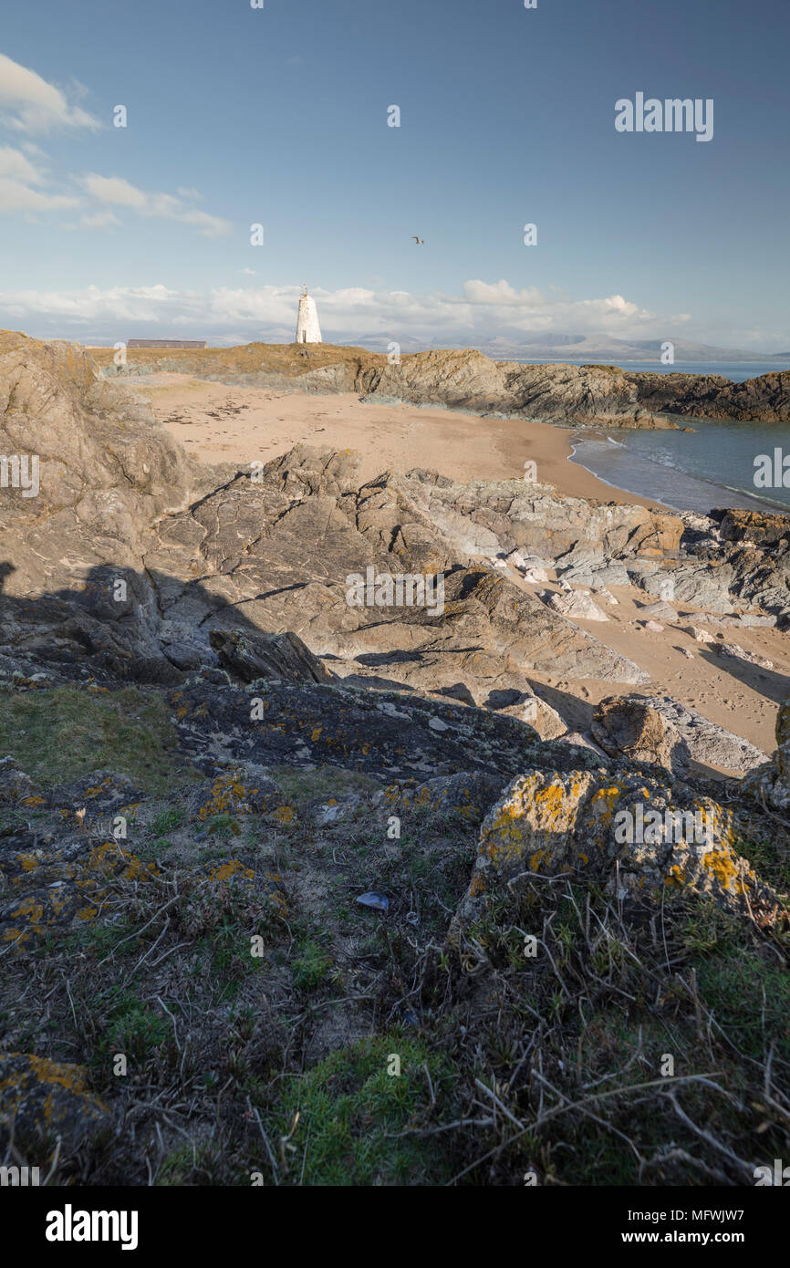 Warm sunlight over tidal island Llanddwyn in Anglessey, North Wales, UK ...
