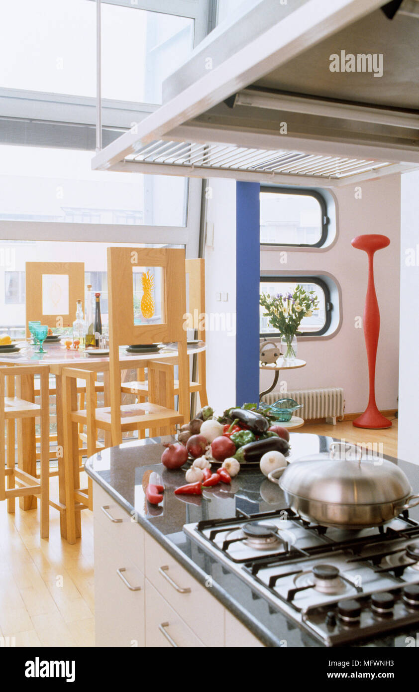 Cooking pot on gas hob set in kitchen unit in open plan kitchen with ...
