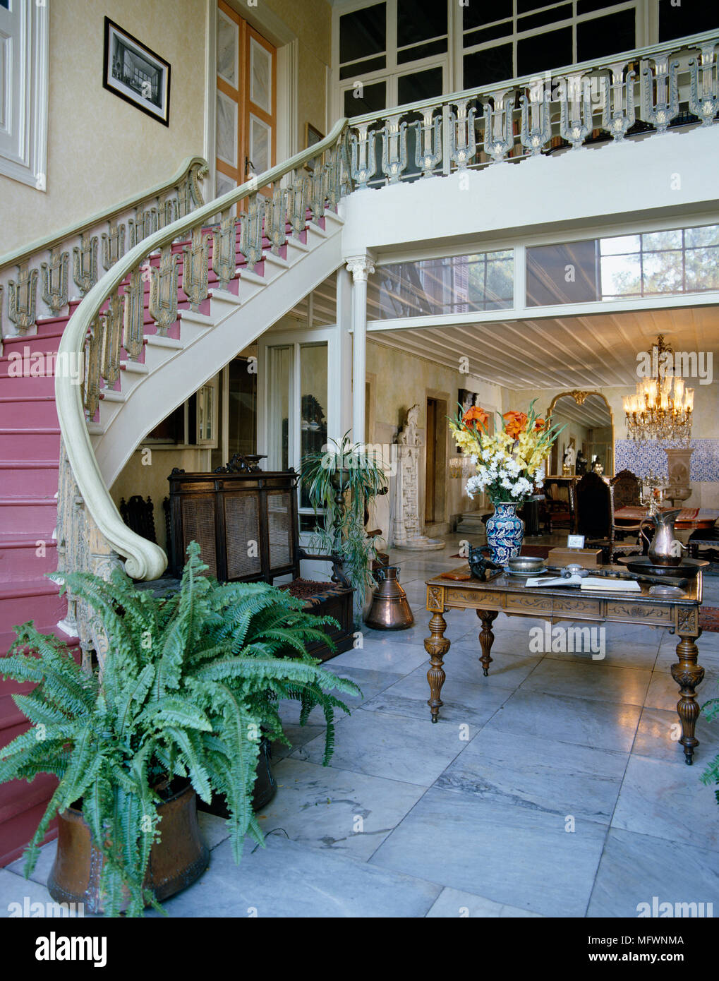 Grand sweeping staircase leading down to tiled hallway Stock Photo - Alamy