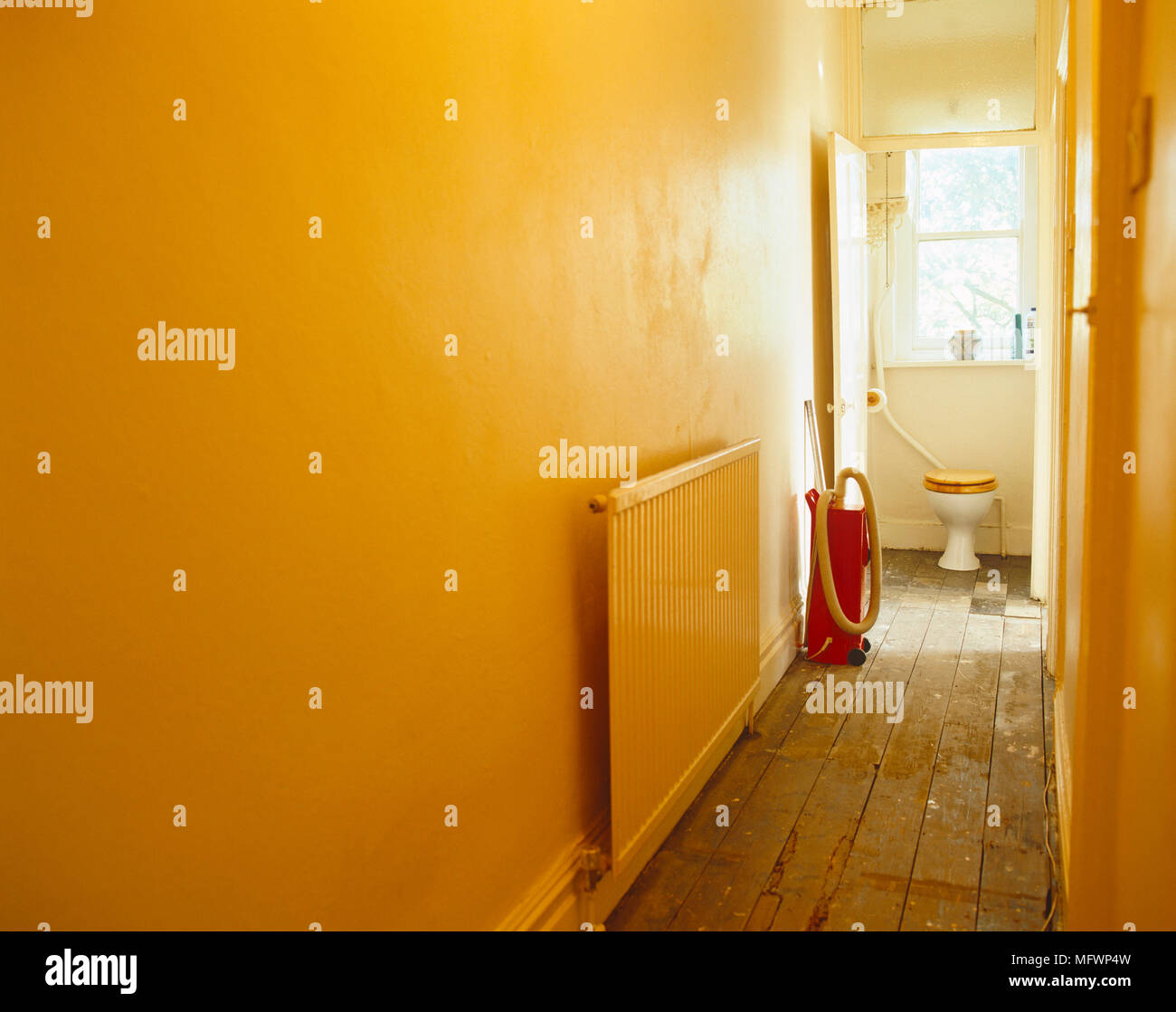 Vacuum cleaner standing in hallway with view of toilet cloakroom Stock ...