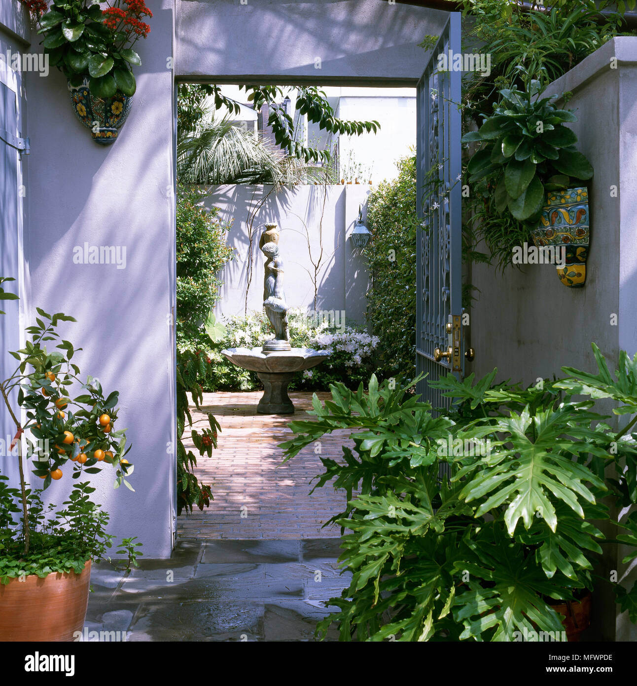 Secluded courtyard patio with fountain and plants Stock Photo - Alamy