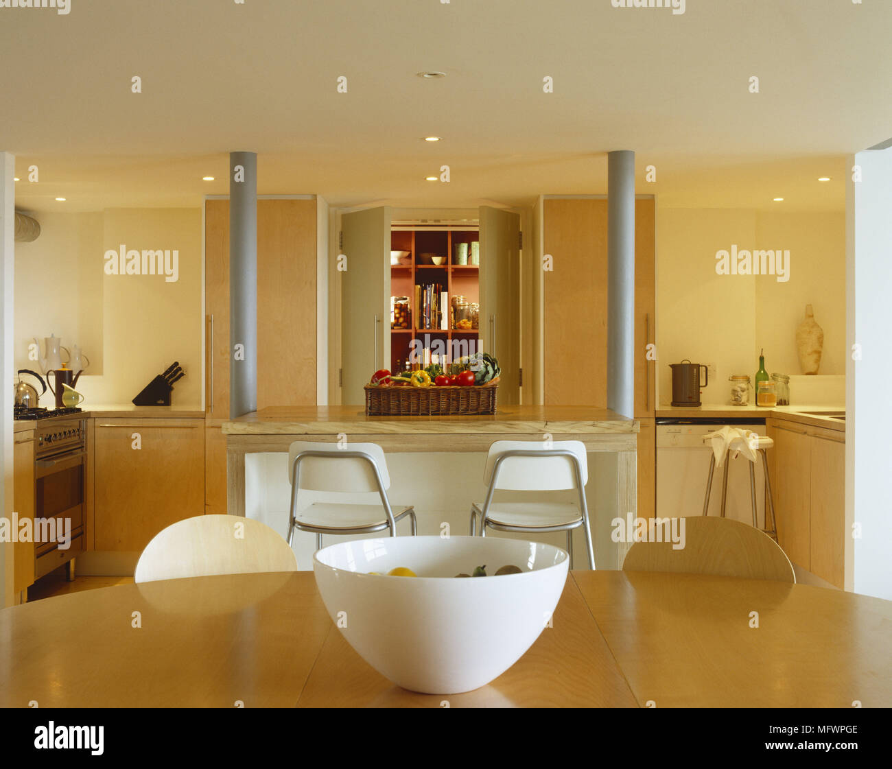 Open plan kitchen with dining area with table and chairs Stock Photo ...