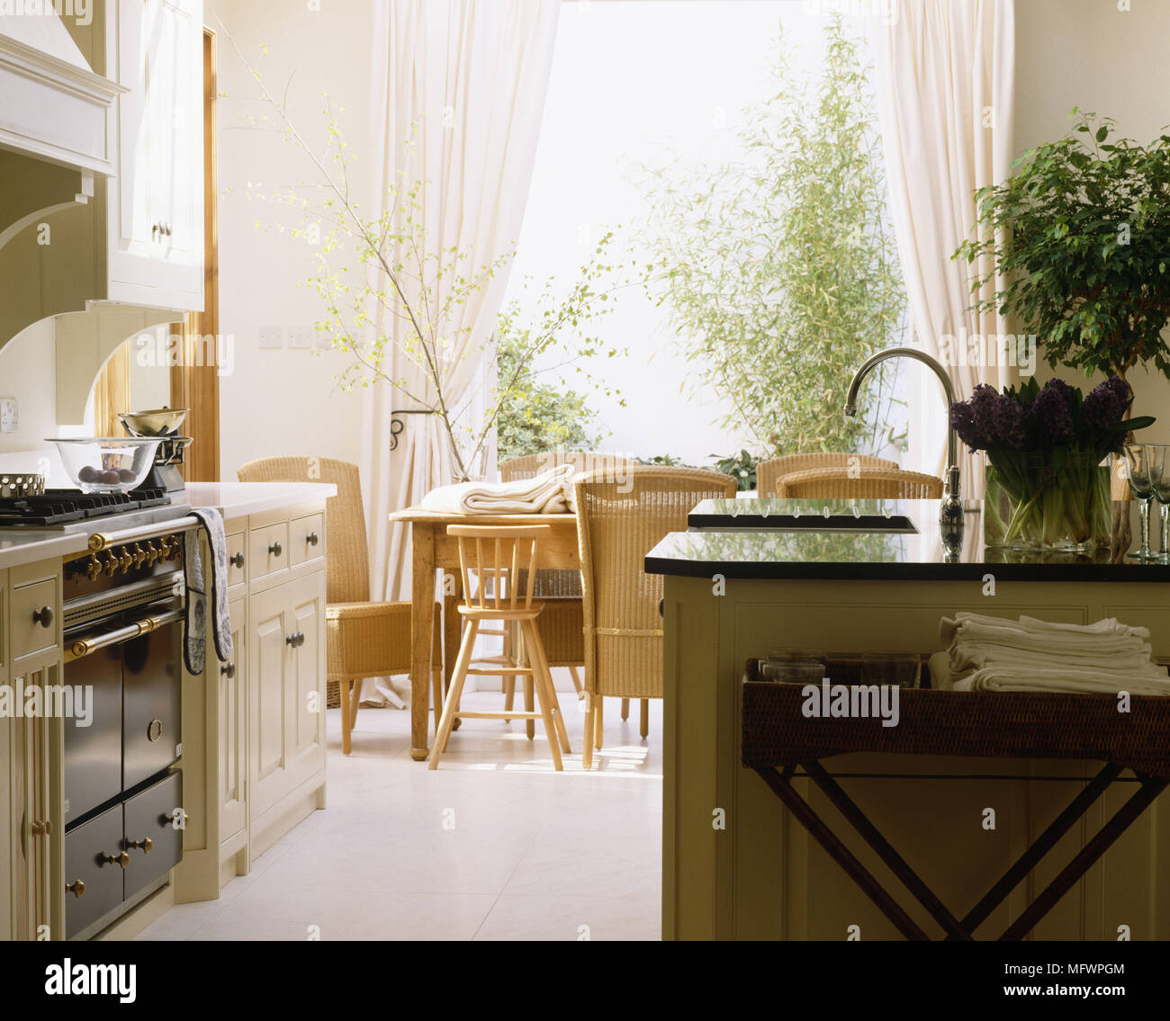 Open plan kitchen with dining area with table and chairs Stock Photo ...