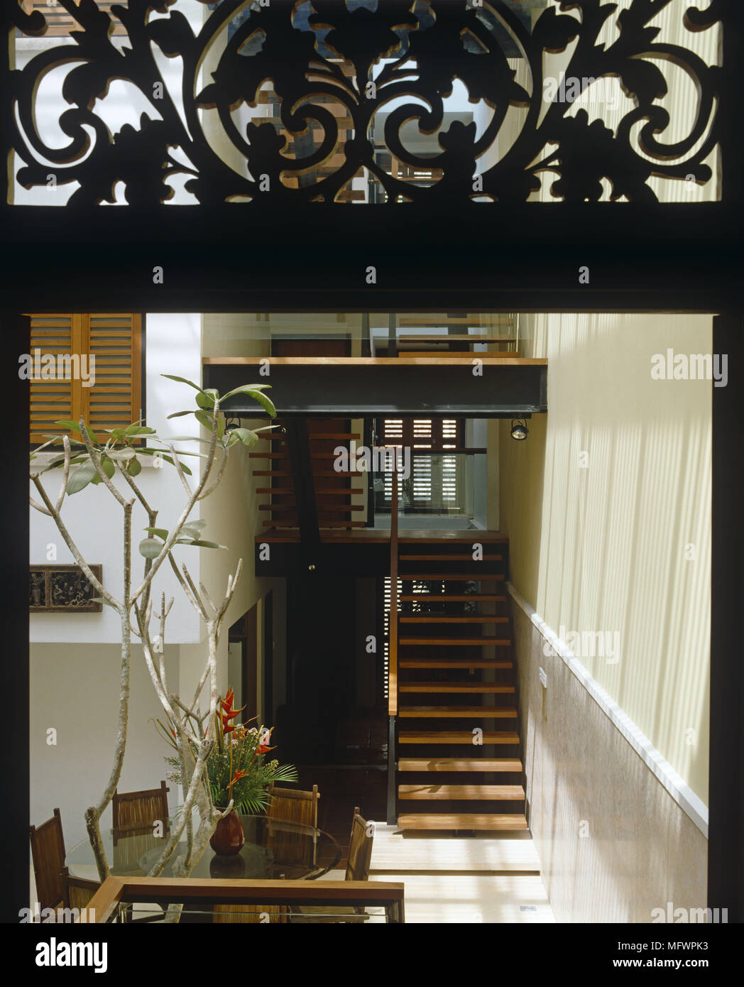 Elevated view through window to indoor courtyard with staircase Stock ...