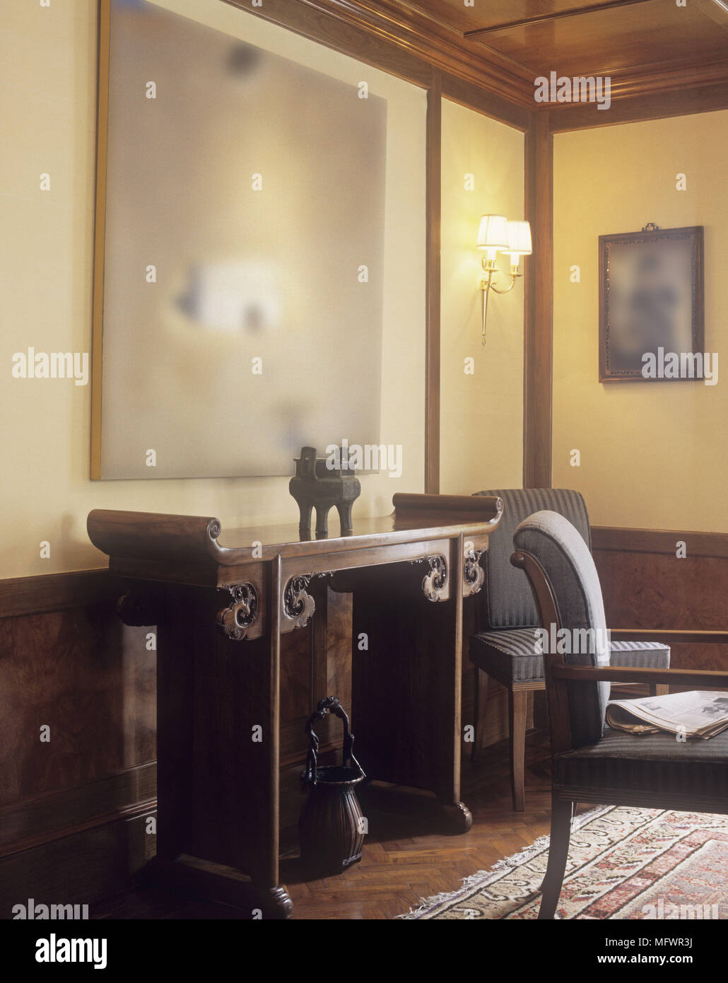 Artwork above wooden side table Stock Photo - Alamy