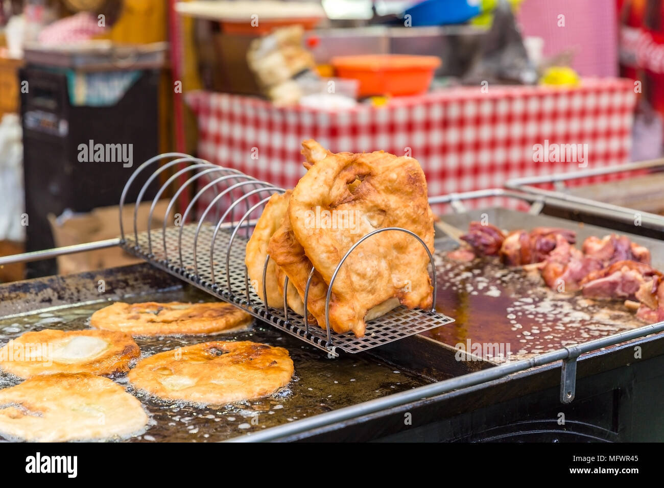 Traditional Hungarian street food Langos at fair. Langos frying in ...