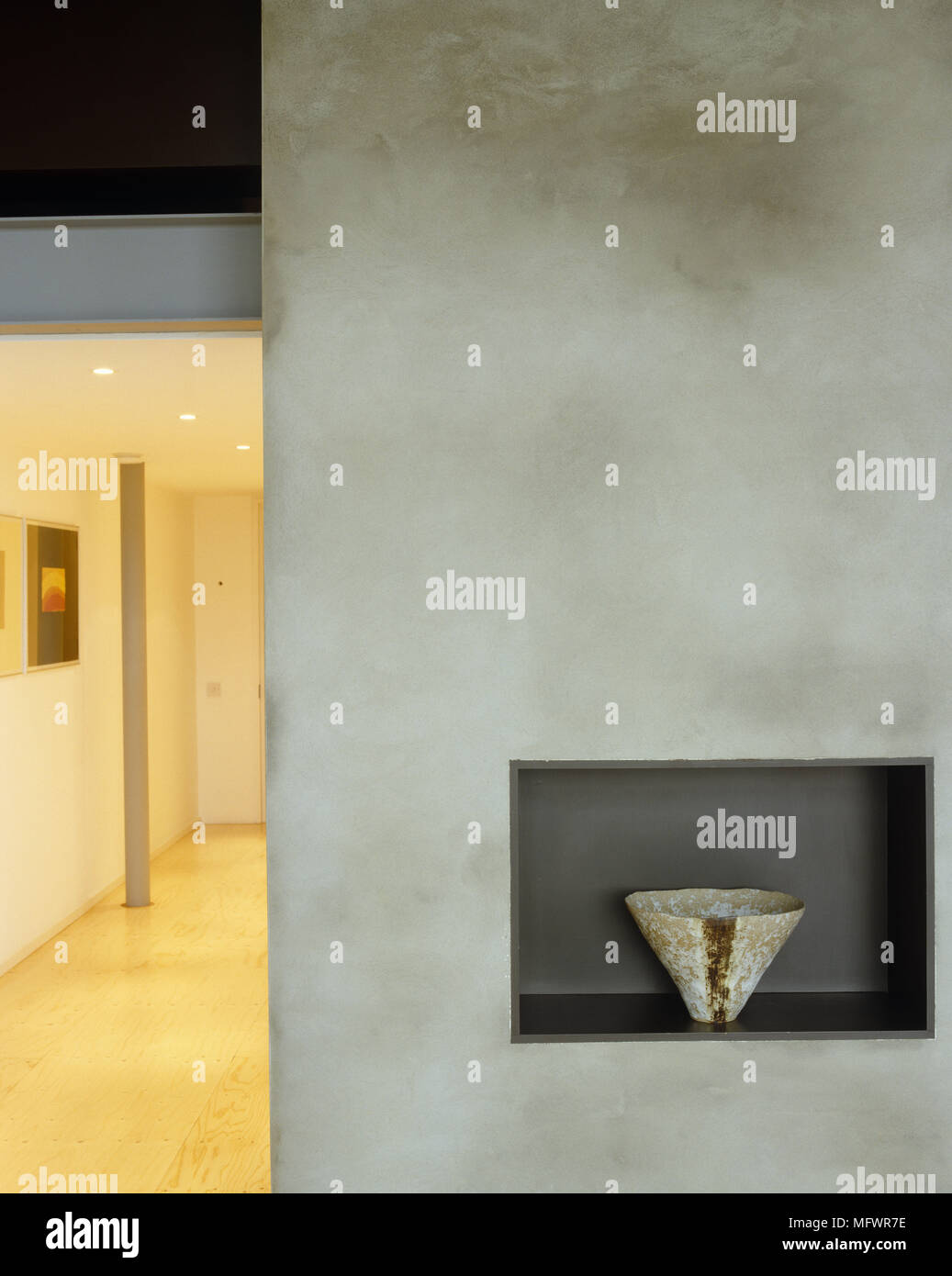 Ornamental bowl with inset shelf next to illuminated corridor Stock ...