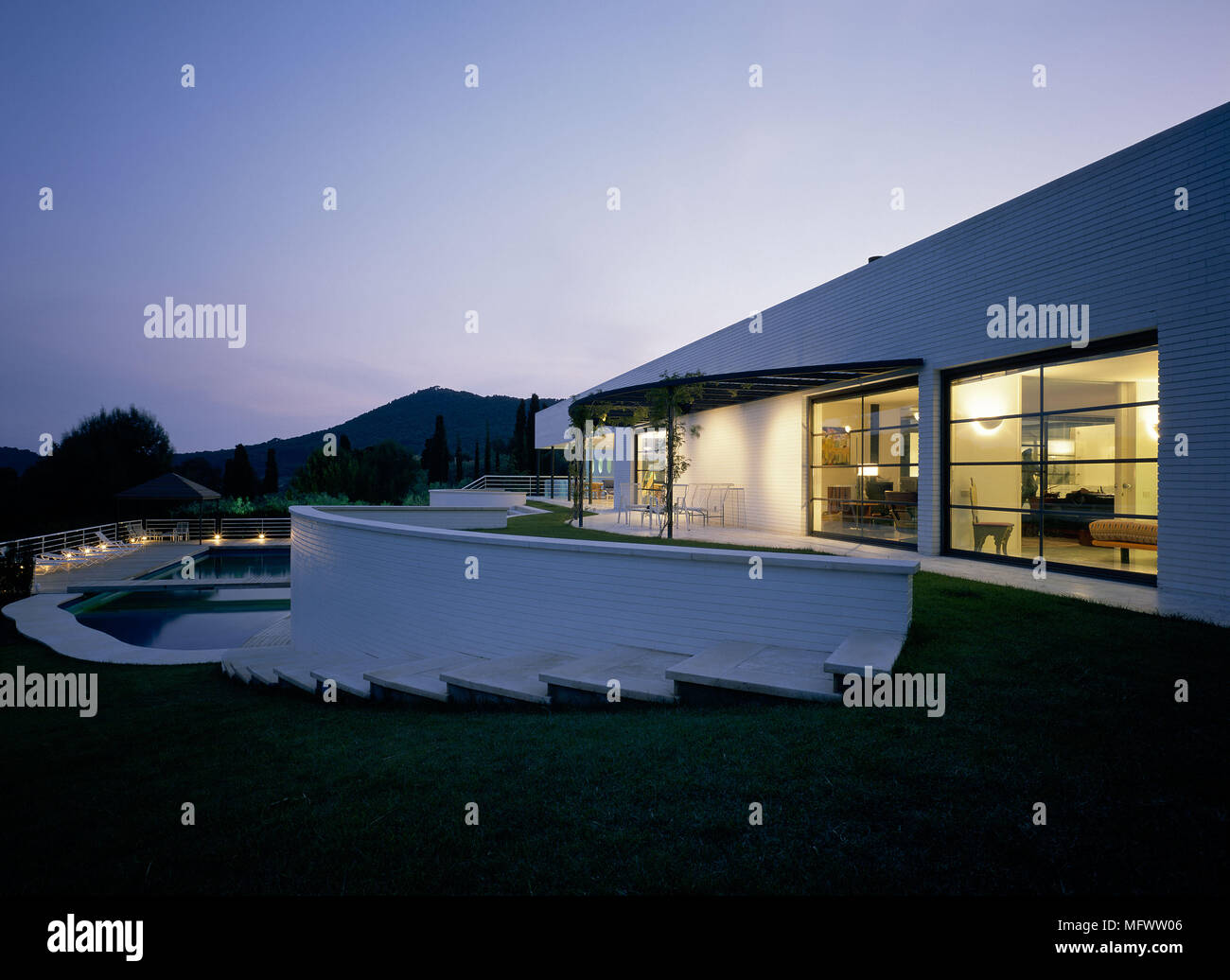 Partial view of a lit house in the evening Stock Photo - Alamy