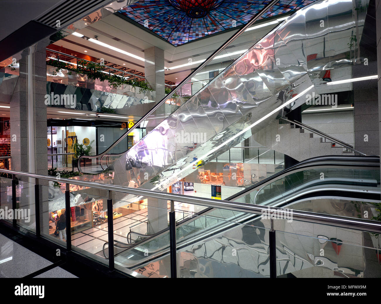 View of escalators in a grand shopping mall Stock Photo - Alamy