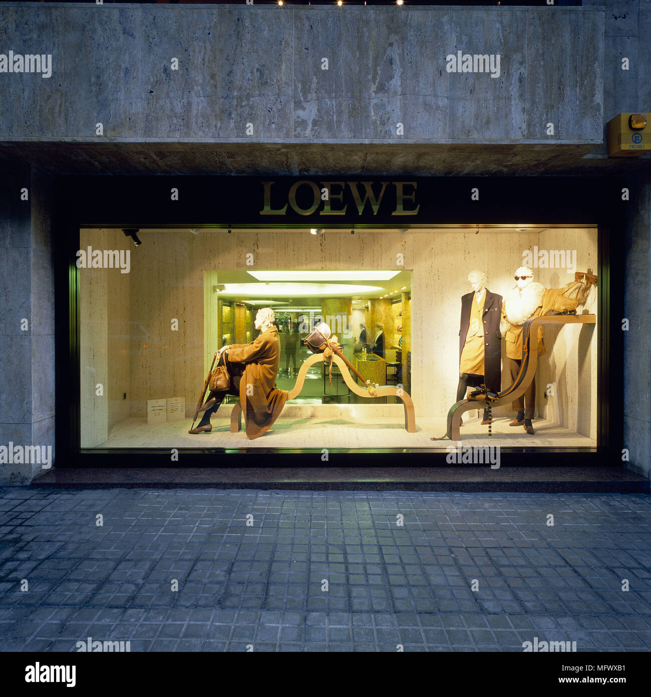 View of manikins on display through a shop window Stock Photo - Alamy