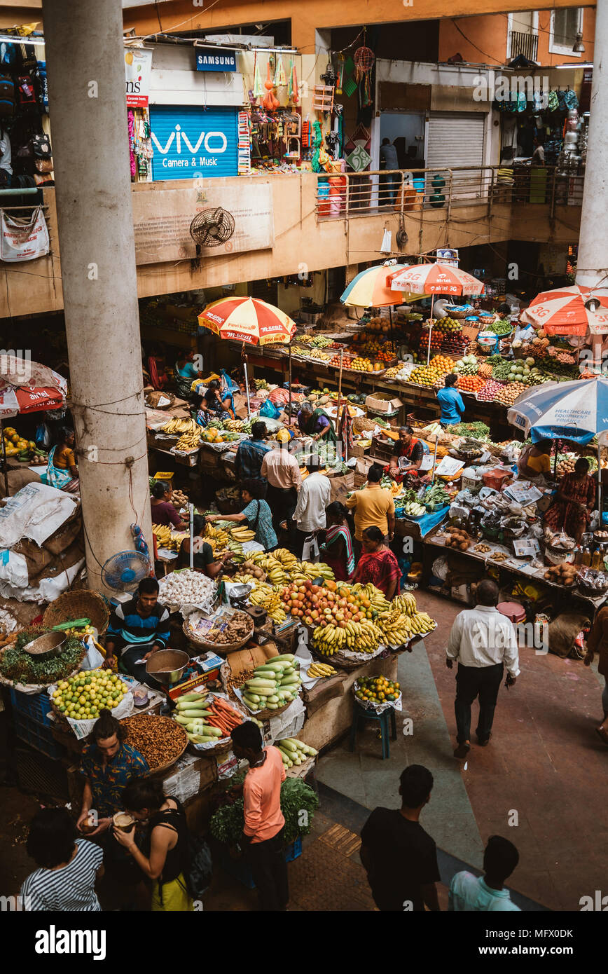 colorful busy fruit and produce market on a warm day in tropical Goa ...